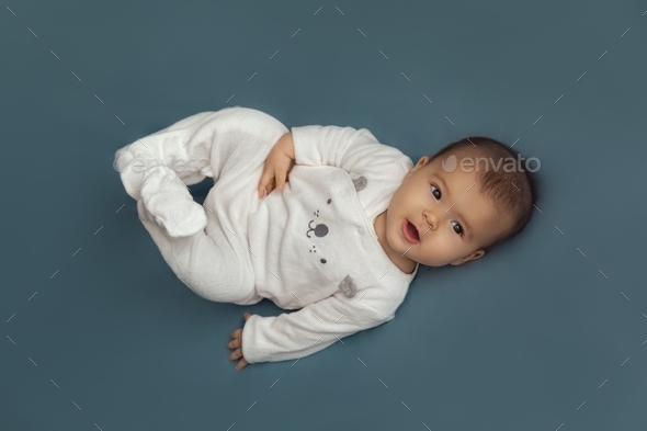 Newborn baby girl on blue, top view Stock Photo by evgeniyaphotography