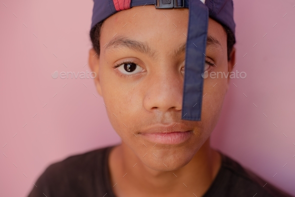 Portrait of teenager with cap turned backwards. Stock Photo by rushay1977