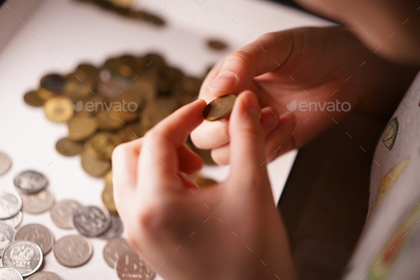 Checking and inspecting different coins, searching for a rare coin ...