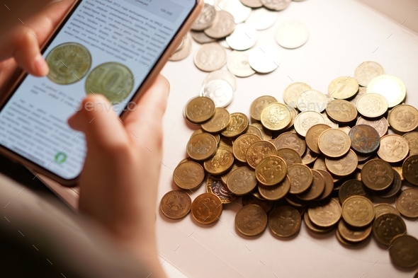 Checking and inspecting different coins, searching for a rare coin ...