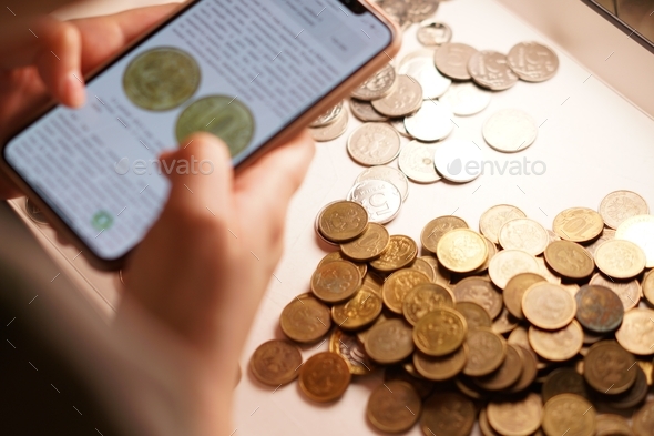 Checking and inspecting different coins, searching for a rare coin ...