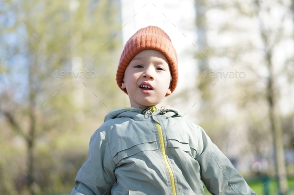 3 year old boy with a hat, showing a smirk on his face Stock Photo by ...