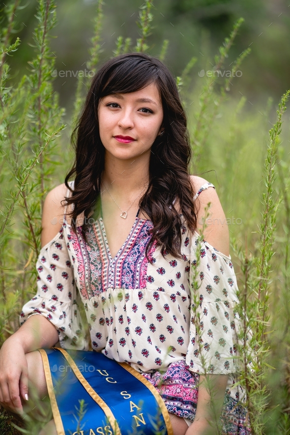 Recent college graduate posing for the camera. Graduation photo session ...