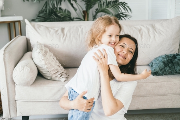 Mother Gently Hugs Her 4 Year Old Daughter Daughter And Mother At Home