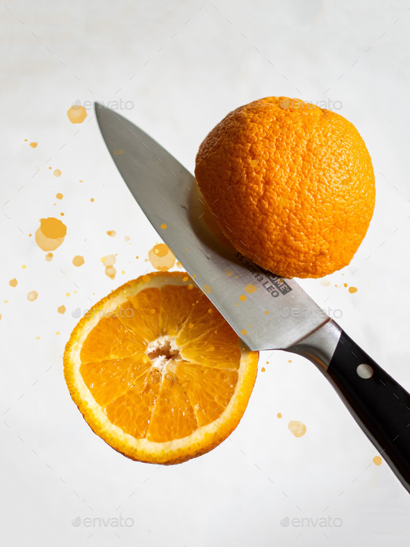 Cutting orange by knife Stock Photo by VeraPolly | PhotoDune
