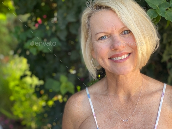 Beautiful blonde baby boomer with dimples smiles Stock Photo by ...