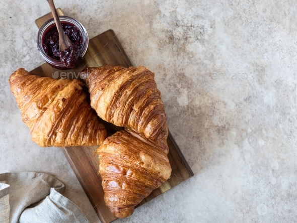 Fresh crispy croissants with jam, concrete background. Homemade bakery ...