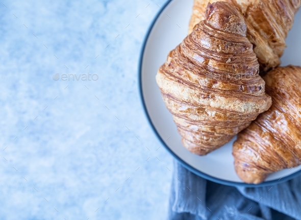 Tasty crispy croissants, blue concrete background. Stock Photo by ...