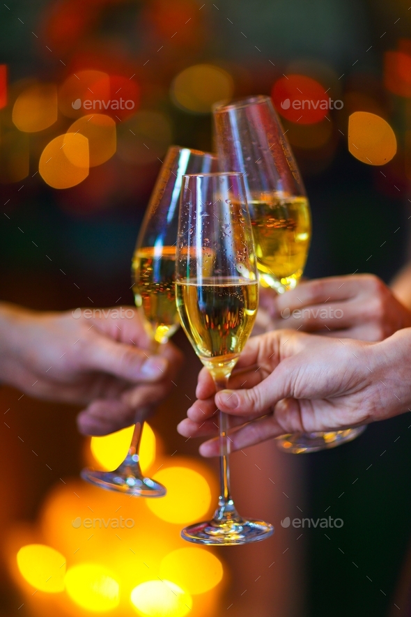 Holiday illuminations and champagne glass. Christmas party. Toast Stock ...