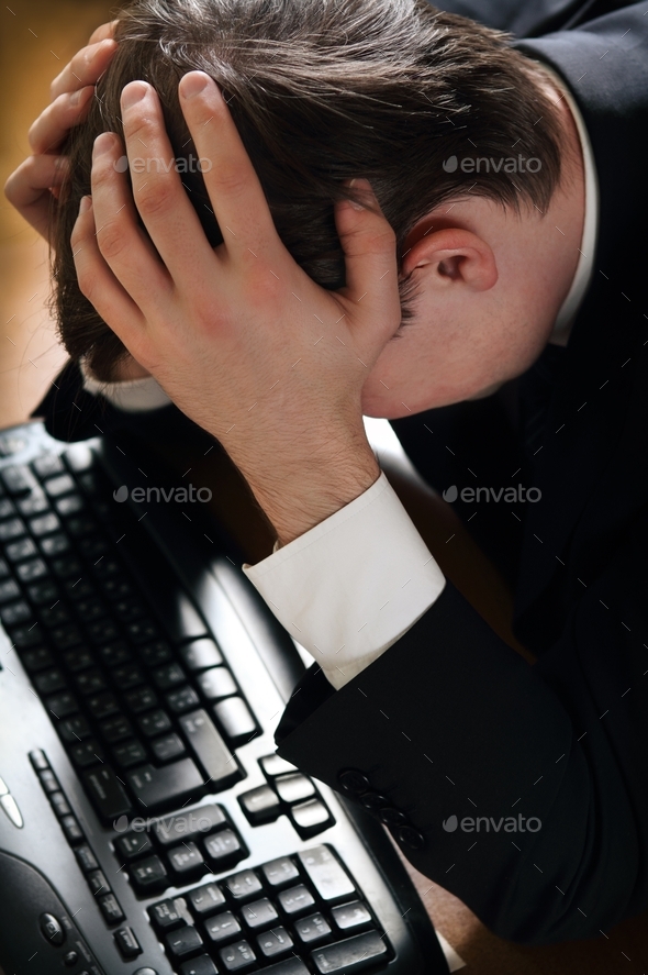 Depressed business man sitting at workplace and grieving Stock Photo by ...