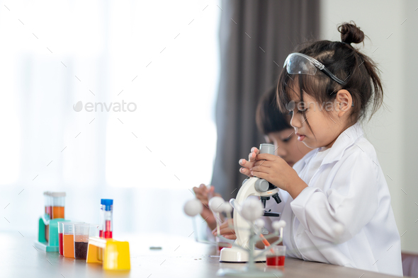 kids or students with test tube making experiment at school laboratory ...