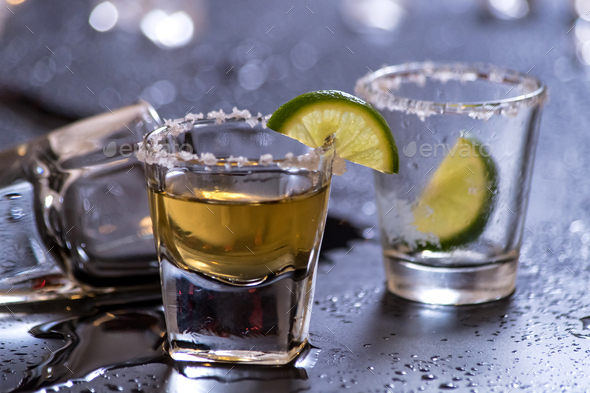 The alcohol shot glasses with salt and lime slice Stock Photo by Studio_OMG