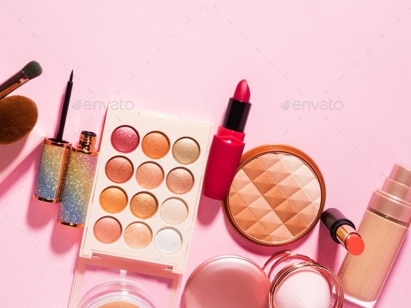 Different make up beauty cosmetics products on pink pastel background ...