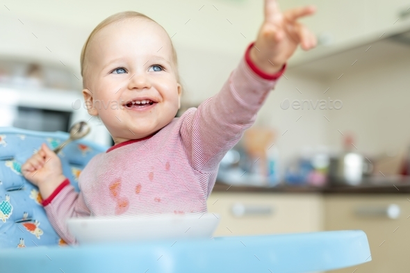 Cute happy adorable infant baby boy enjoy having fun sit in chair ...