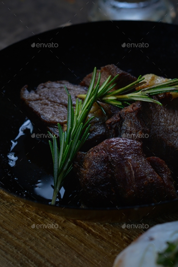 Rosemary on sautéed loins. Soft meat Stock Photo by jdvolcan | PhotoDune