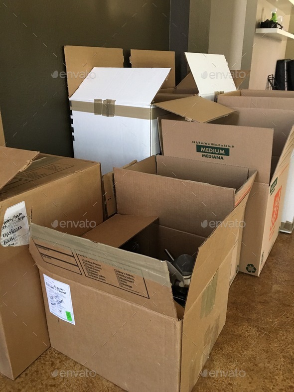 Many cardboard boxes ready to be closed and transported to a new house ...