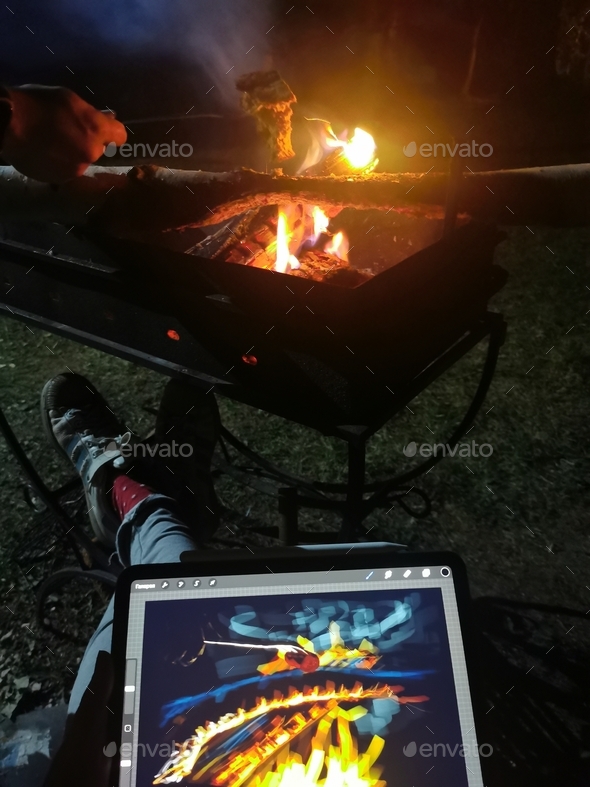 Evening chill by grill fireplace. Drawing fire on pad Stock Photo by ...