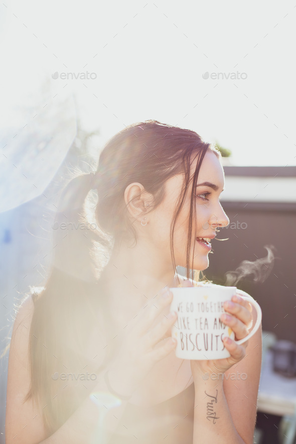 Beautiful woman side profile holding steaming cup of coffee Stock Photo ...