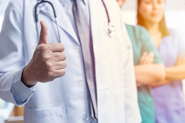 Doctor medical team with hand thumbs up positive sign for good care ...