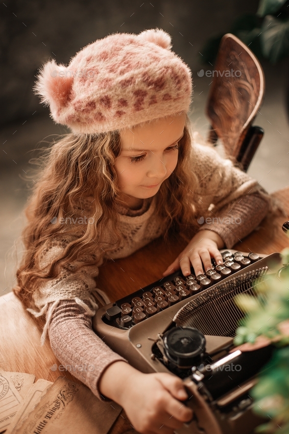 Little girl typing on vintage typewriter at wooden table Stock Photo by ...