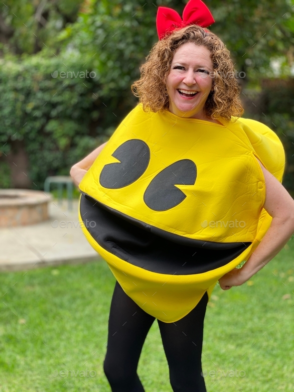 laughing woman wearing yellow Ms PacMan costume for Halloween in the ...