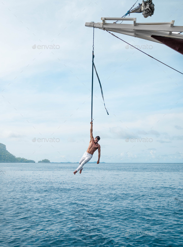 Hanging circus straps from the front of a boat Stock Photo by rikkicarman1