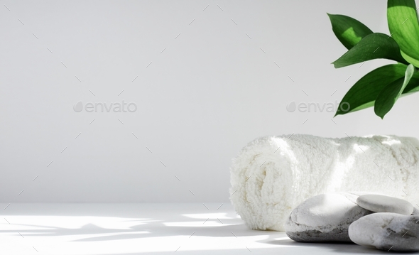 Spa background concept. Towel and stones on a white background with ...