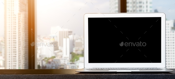 Computer, laptop with blank screen on wood table with office window ...