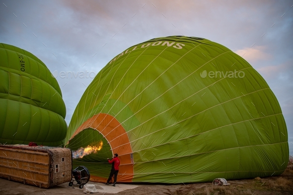 Balloonist pilot inflates hot air balloon before start launching and ...