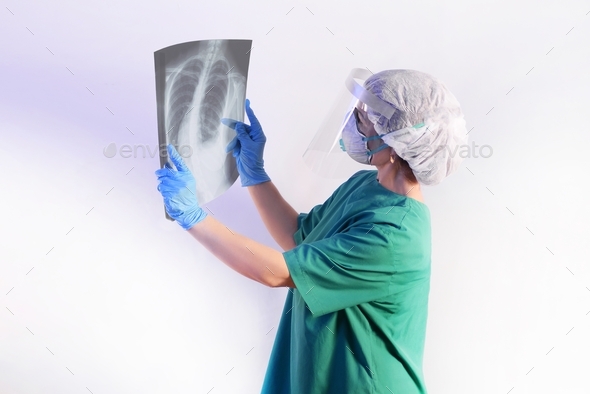 Doctor surgeon in overalls uniform examines an x-ray of the lungs Stock ...