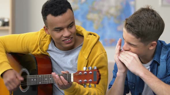 Two Teen Friends Enjoy Playing Guitar and Harmonica Together, Musical ...