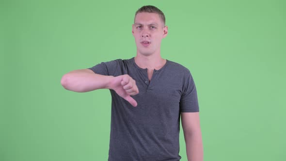 Portrait of Angry Young Man Giving Thumbs Down, Stock Footage | VideoHive