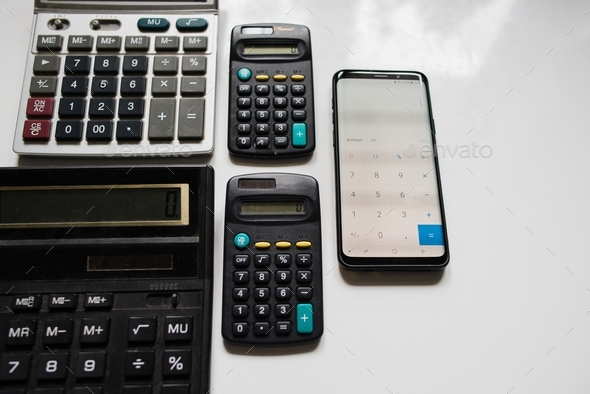 Different calculators and phone with calculator turned on Stock Photo ...