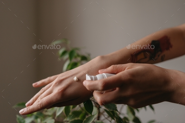 woman's hands close up, using cosmetics for hands, cream moisturizing ...
