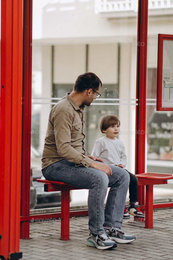 Boy with dad at the bus stop Stock Photo by Sashasky006 | PhotoDune