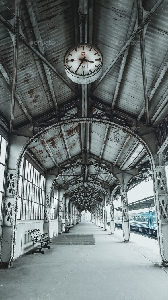 An empty platform at the railway station with a train. The old railway ...
