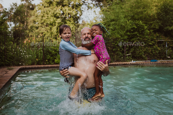 Dad in the pool having fun with his kids Stock Photo by garick | PhotoDune