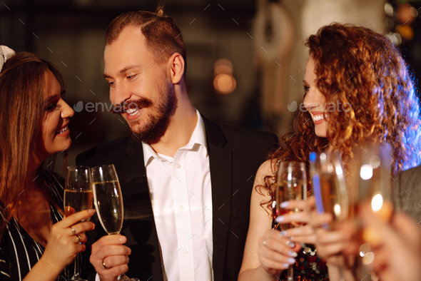 Cheering,drinking cocktails. Group of friends partying in a nightclub ...