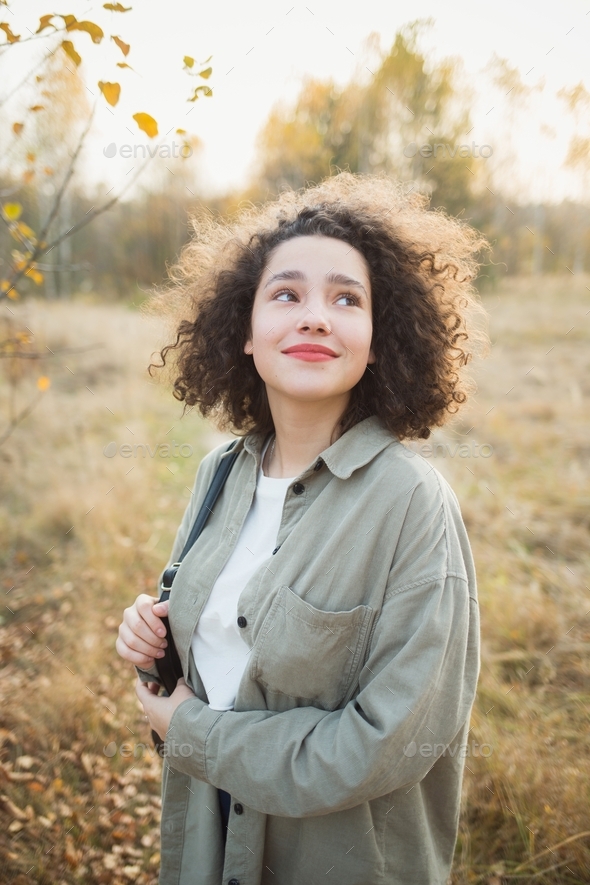 portrait of young pretty mixed race teen girl outdoor in autumn. happy ...