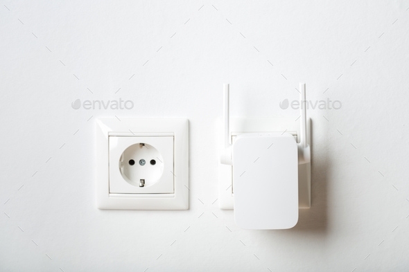 white wi-fi repeater indoors at home in outlet. wireless router. Stock ...