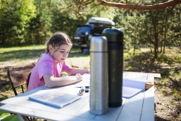 Child girl study lesson outdoors. Family education. Online student ...