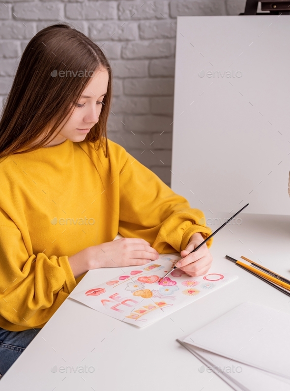 Teenage girl artist drawing a picture using watercolor Stock Photo by ...