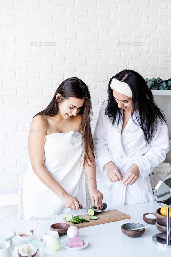 two beautiful women doing spa procedures cutting cucumbers Stock Photo ...