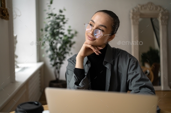woman freelancer uses laptop portrait wearing glasses office work ...