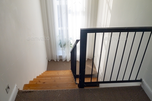 Modern trendy interior of a staircase in a house with a large window ...