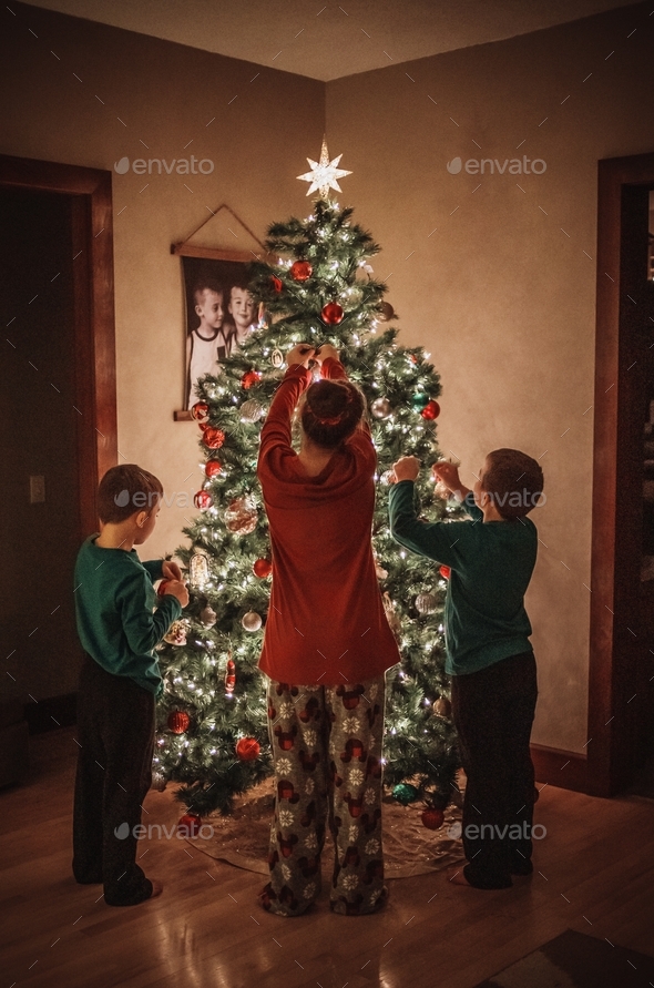 Kids putting the Christmas tree together as a family Stock Photo by ...