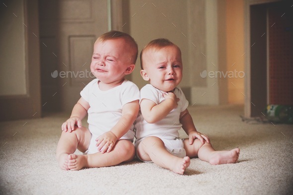 Crying baby twin boys. Crying at home at the same time. Stock Photo by ...