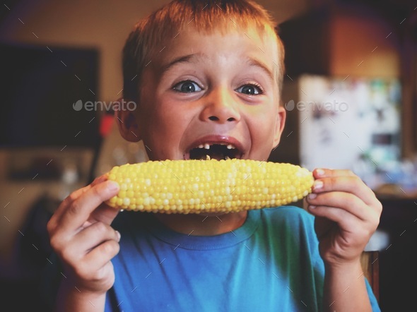 Toothless kid eating corn on the cob Stock Photo by hwilson8 | PhotoDune