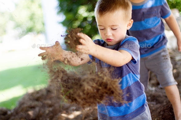 Little boy throwing dirt and getting dirty Stock Photo by hwilson8