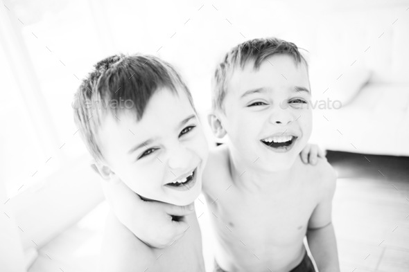 Identical twins laughing together having fun Stock Photo by hwilson8